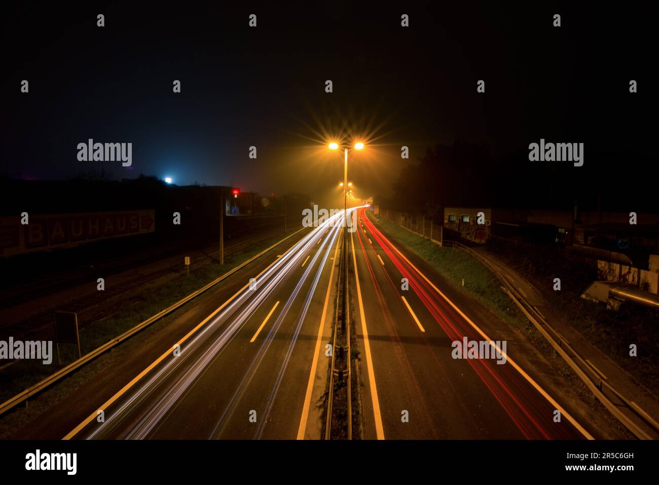 A long exposure of bright light lines on a highway at night Stock Photo ...