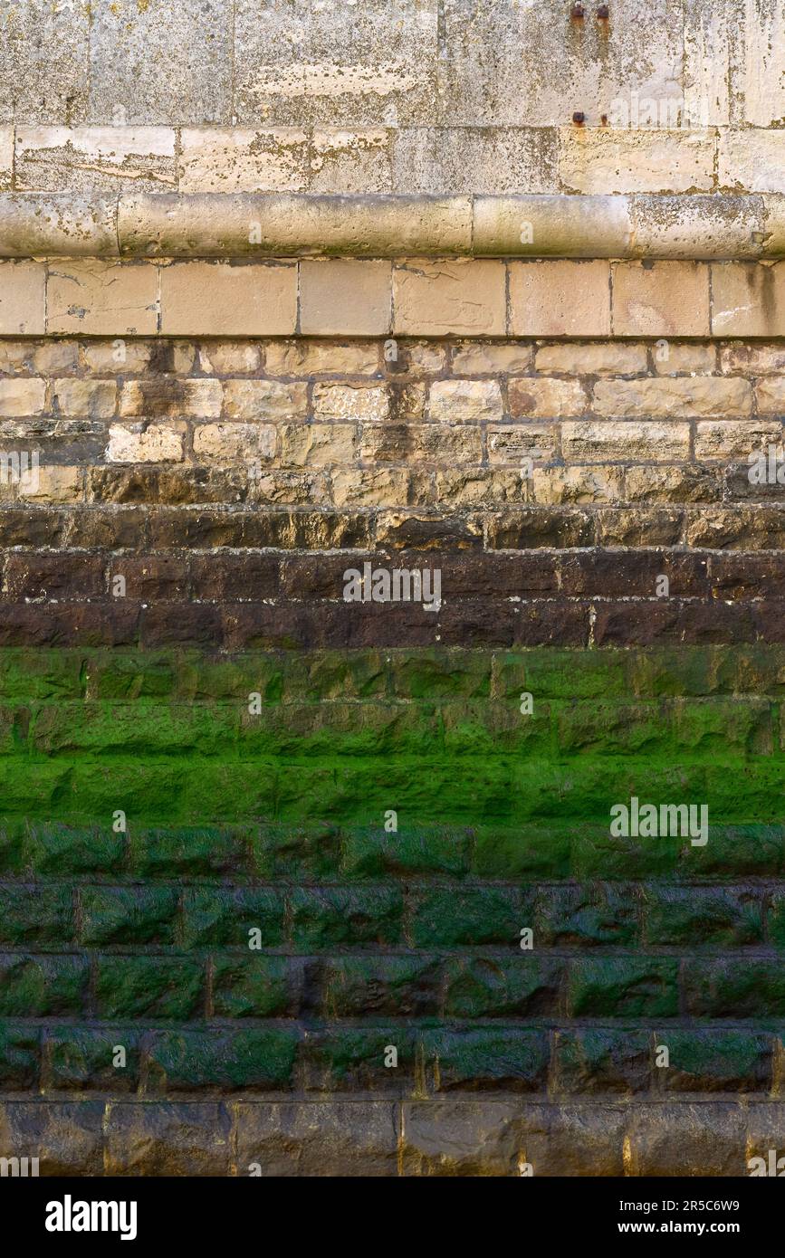 A vertical oriented photograph of a heavy blockwork harbour wall Stock ...