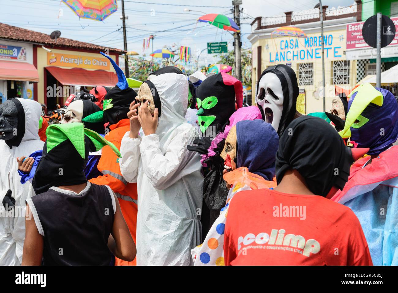 A group of individuals wearing costumes and face masks while walking ...