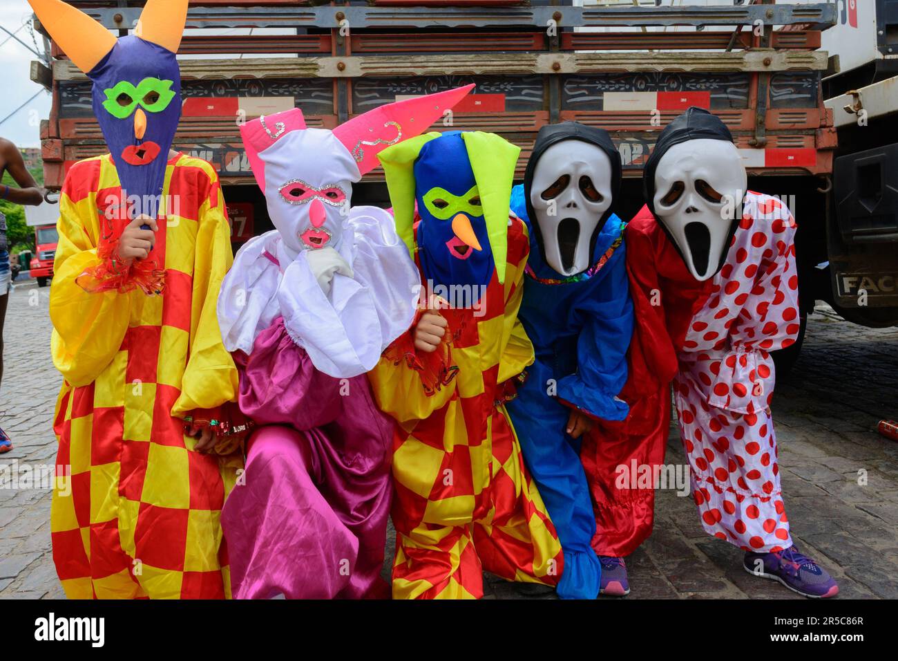 Five individuals wearing colorful clown costumes, posing together in ...