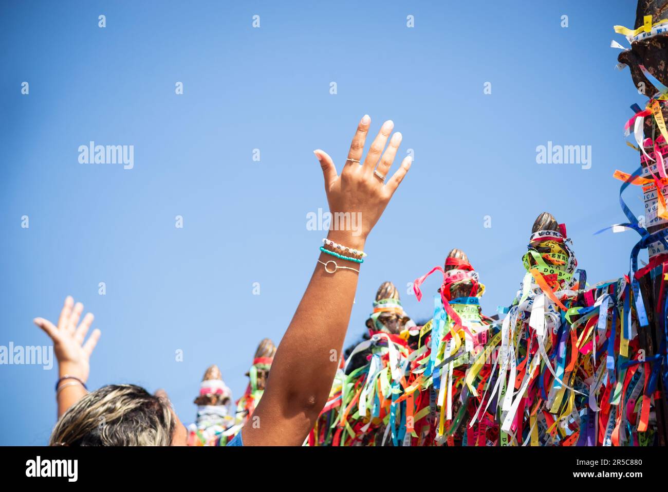 A young Caucasian male stands with his arms raised, looking up at a ...