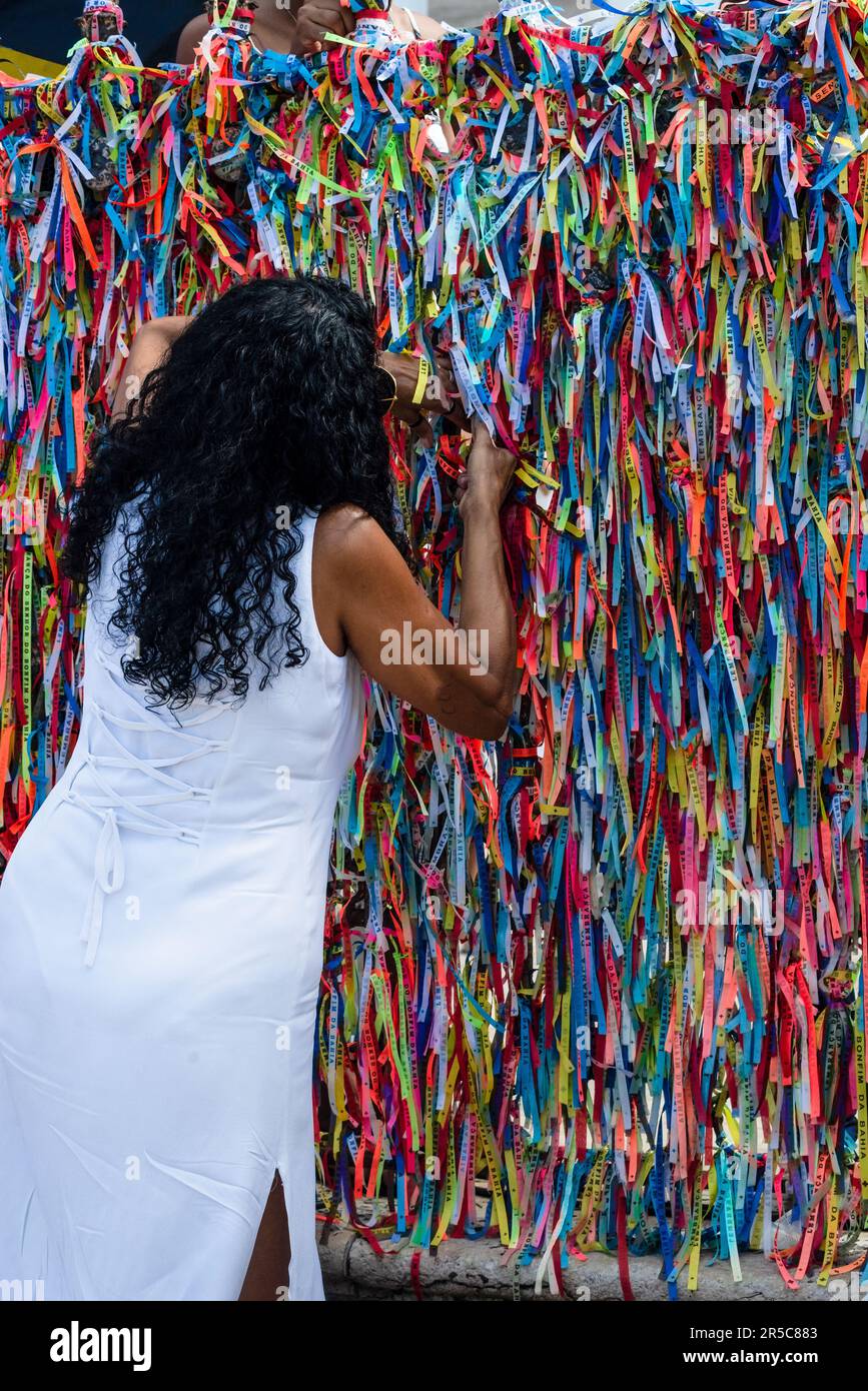 A Caucasian female dressed in a white gown standing in front of a large ...