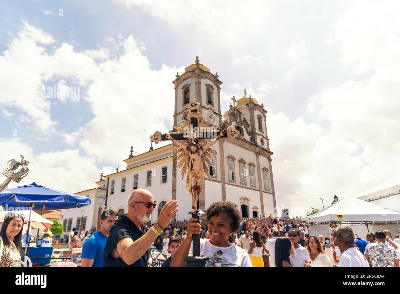 A diverse group of people stands in a bustling street fair, the focus ...