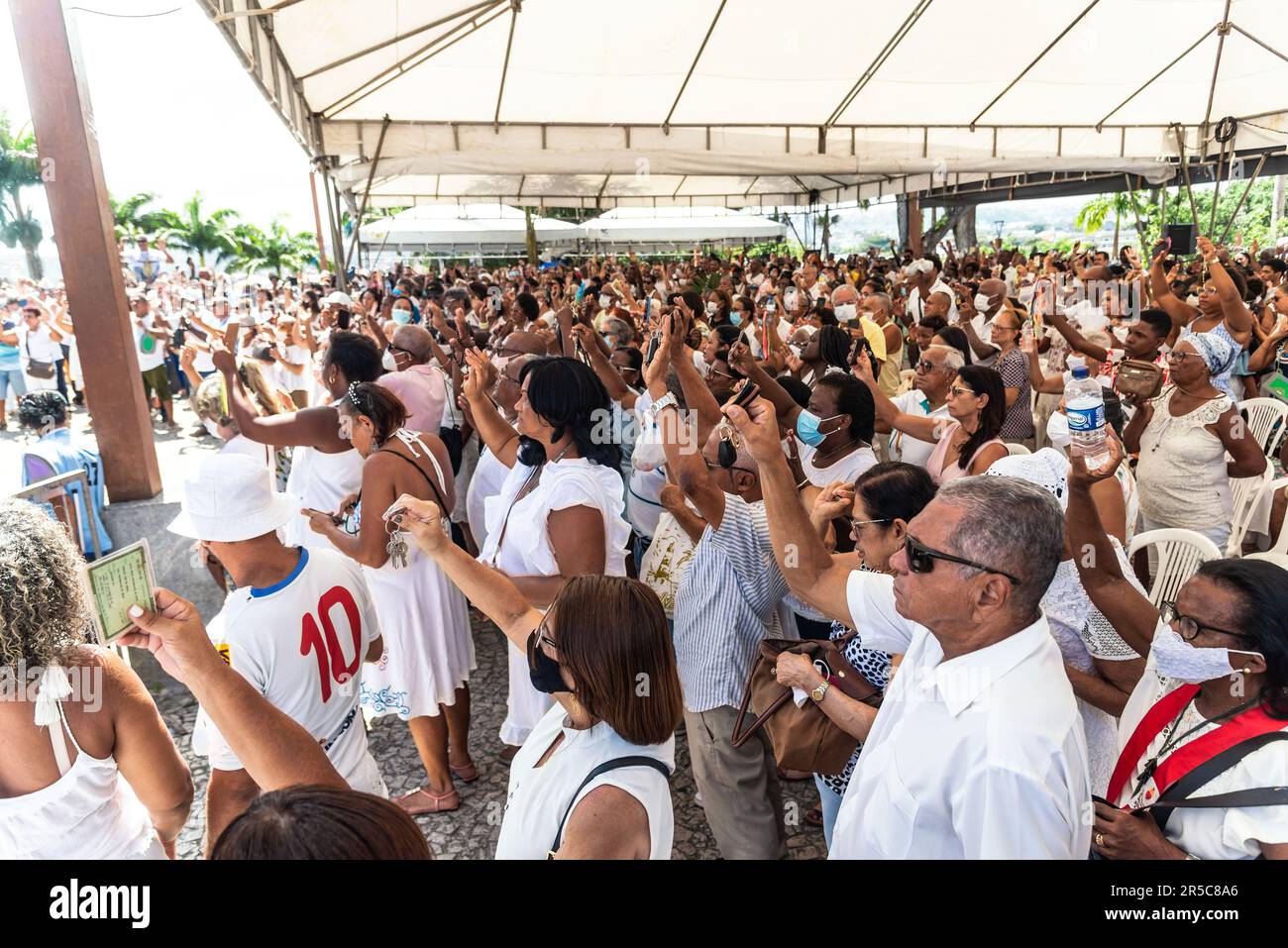 A large gathering of individuals at an outdoor venue enjoying a ...