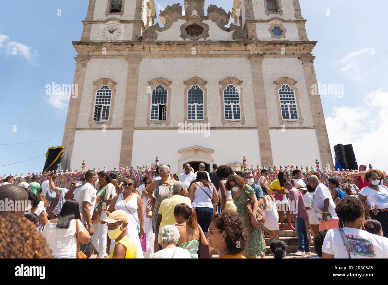 A large group of people are congregated at the base of a tall, pointed ...