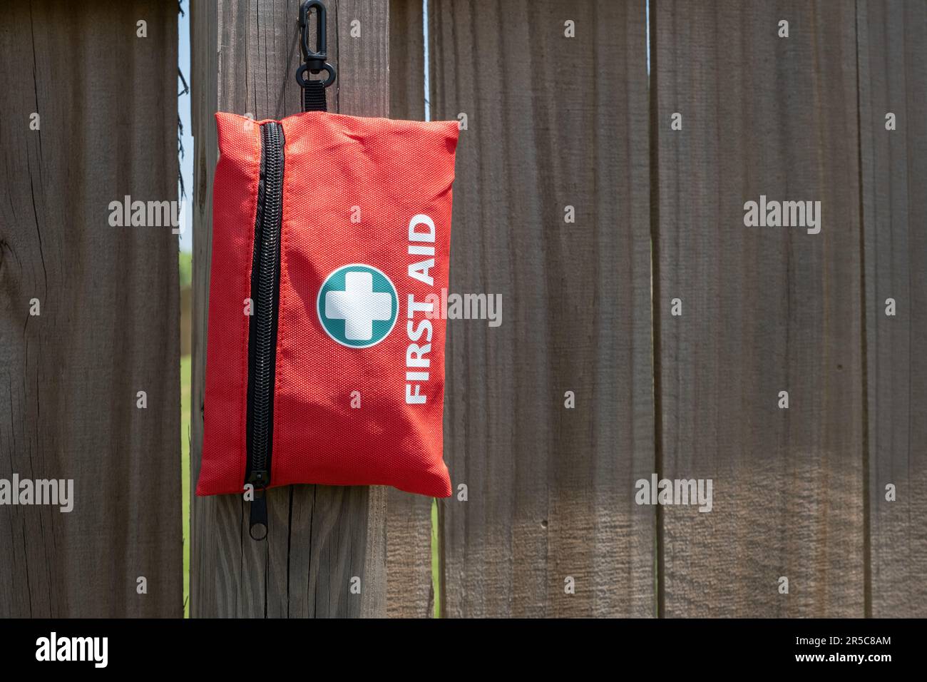 First aid medical kit hanging on a wood fence, copy space Stock Photo ...
