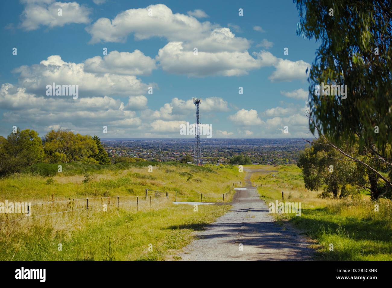 A rural trail on a lush valley with a view of Melbourne, Australia ...
