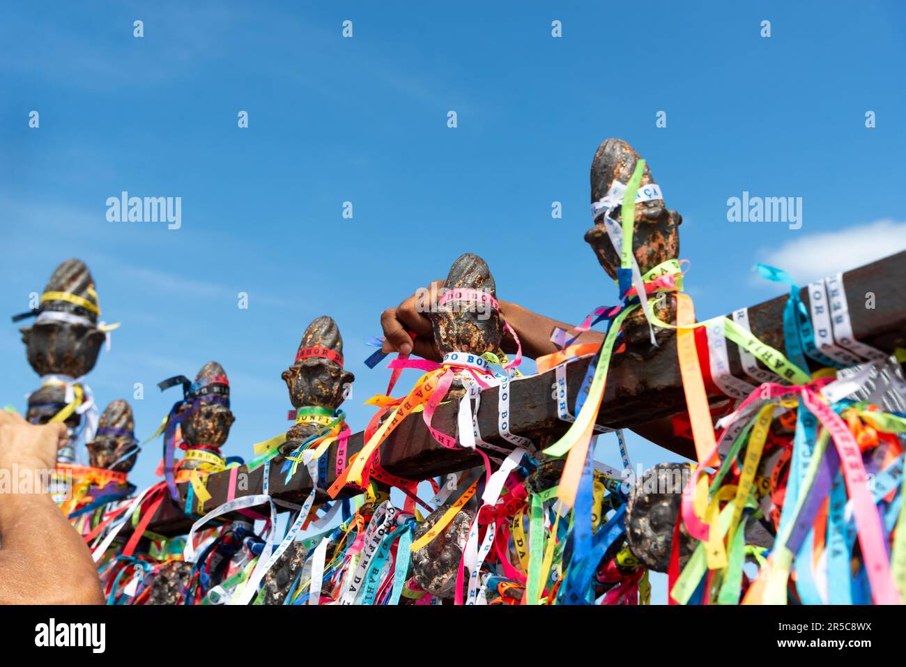 A closeup of colorful ribbons are tied to the side of a building, and ...