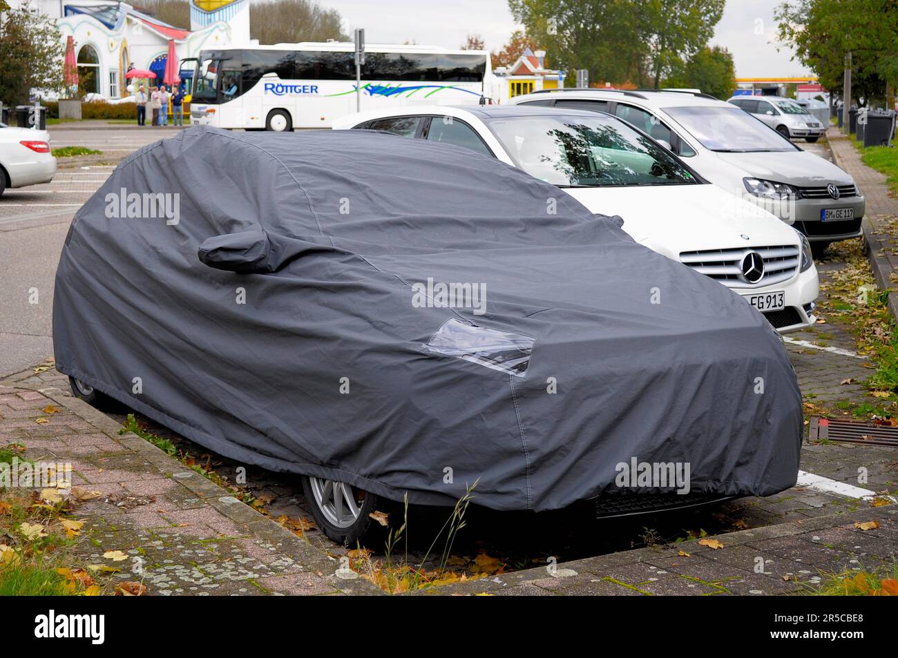Mercedes, test vehicle covered with cover, parked at motorway service ...