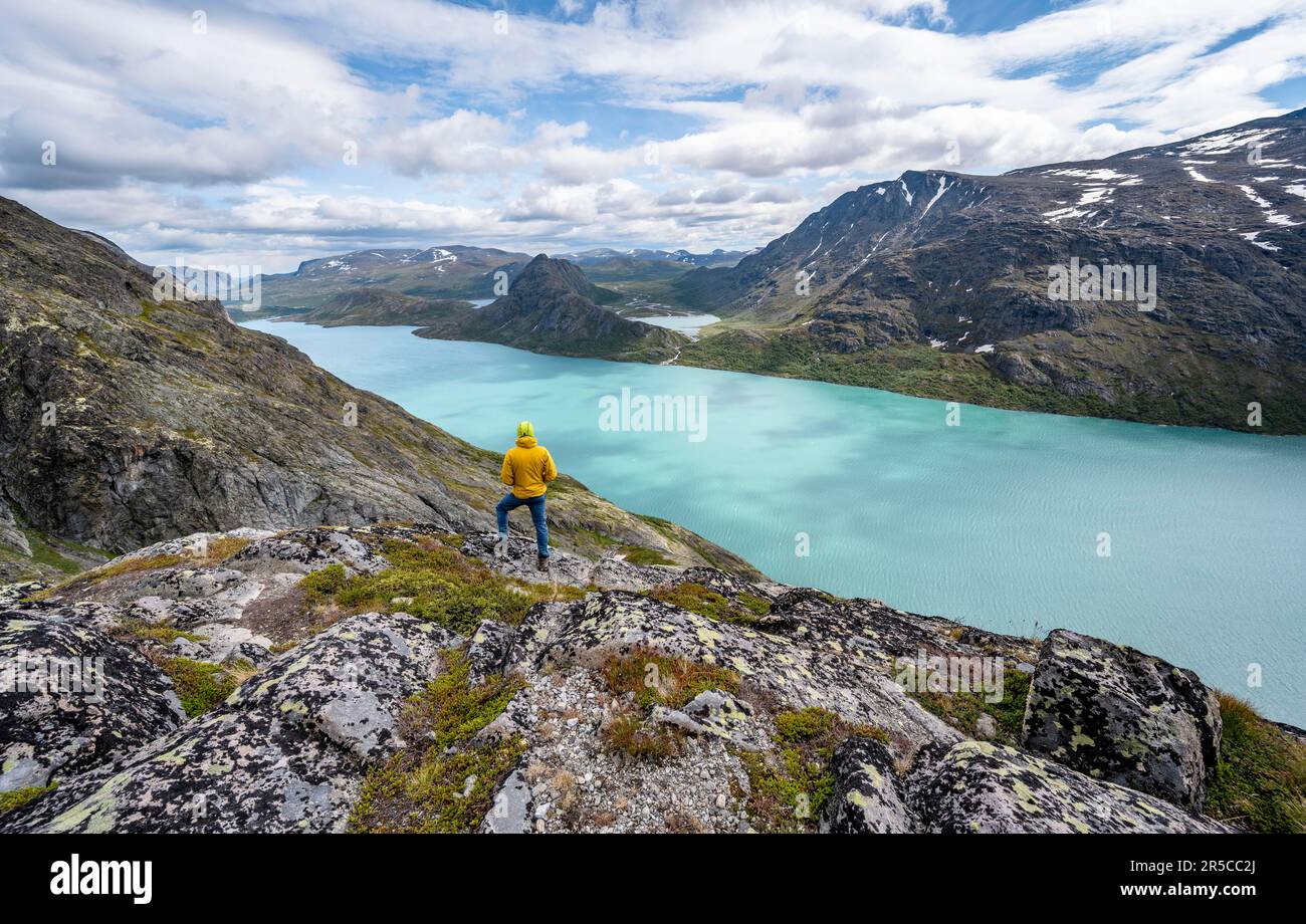 Climbers on the Besseggen ridge, view of lake Gjende behind Knutshoe ...