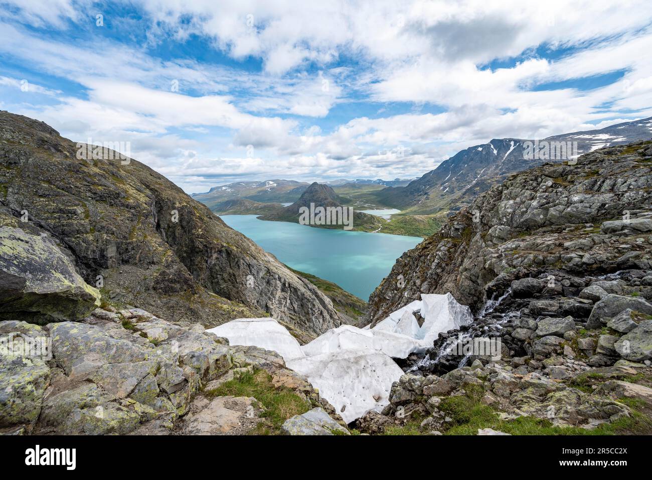 View of Lake Gjende behind Knutshoe Mountain withLake Ovre Leirungen ...
