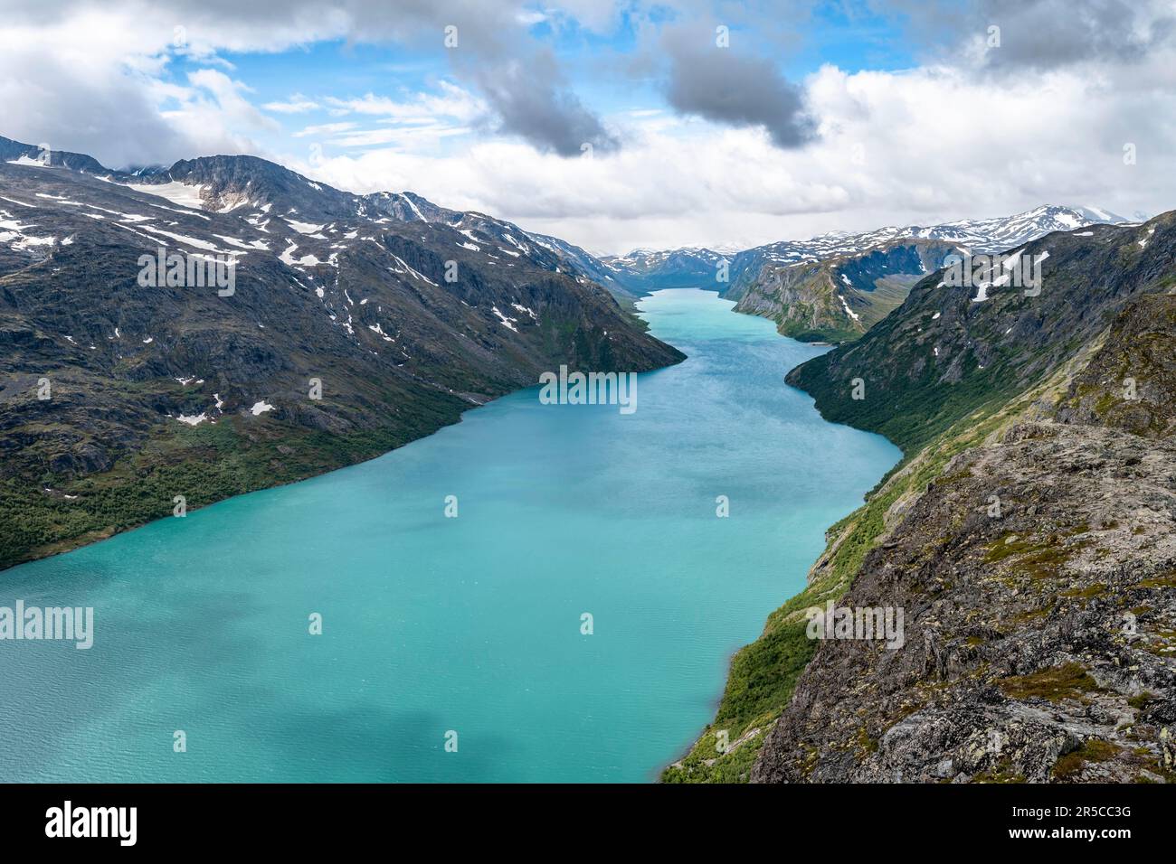 View of Lake Gjende and snowy mountains, Besseggen hike, ridge walk ...