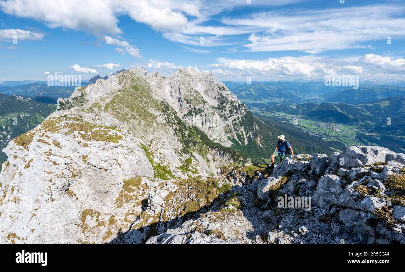 Mountaineer on a narrow ridge path, crossing the Hackenkoepfe, rocky ...