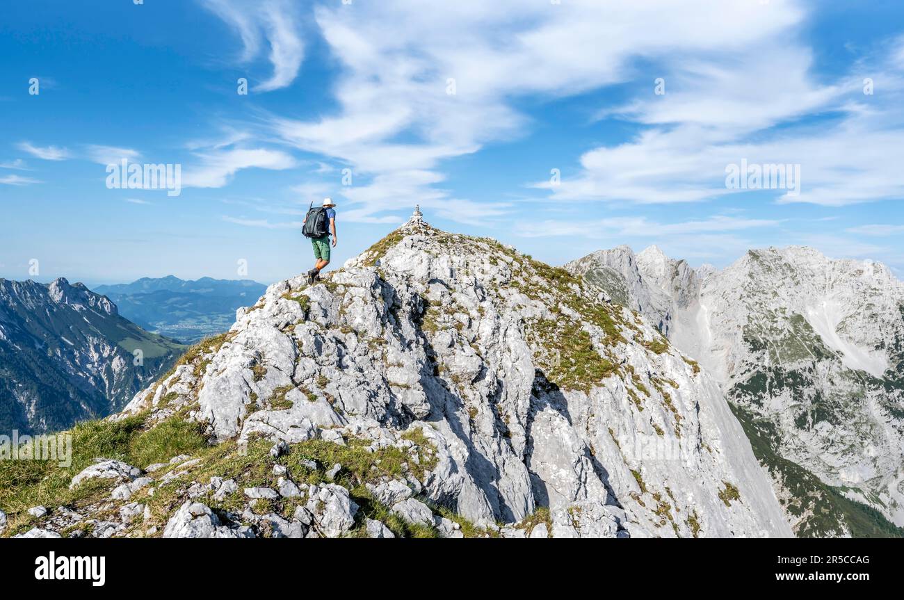 Mountaineer on a narrow ridge path, crossing the Hackenkoepfe, rocky ...