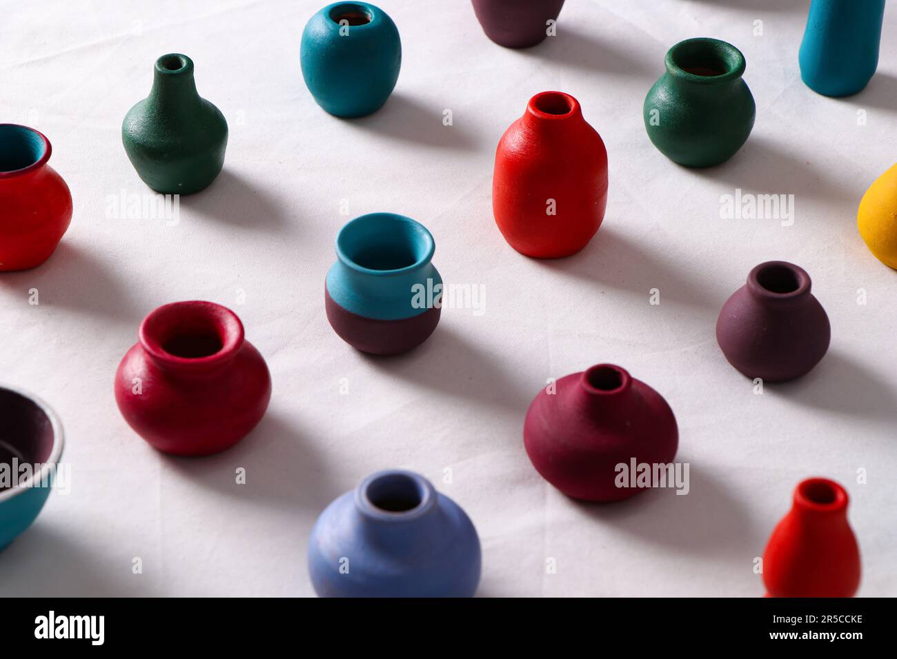 small colorful handmade clay jars , minimalistic Stock Photo - Alamy