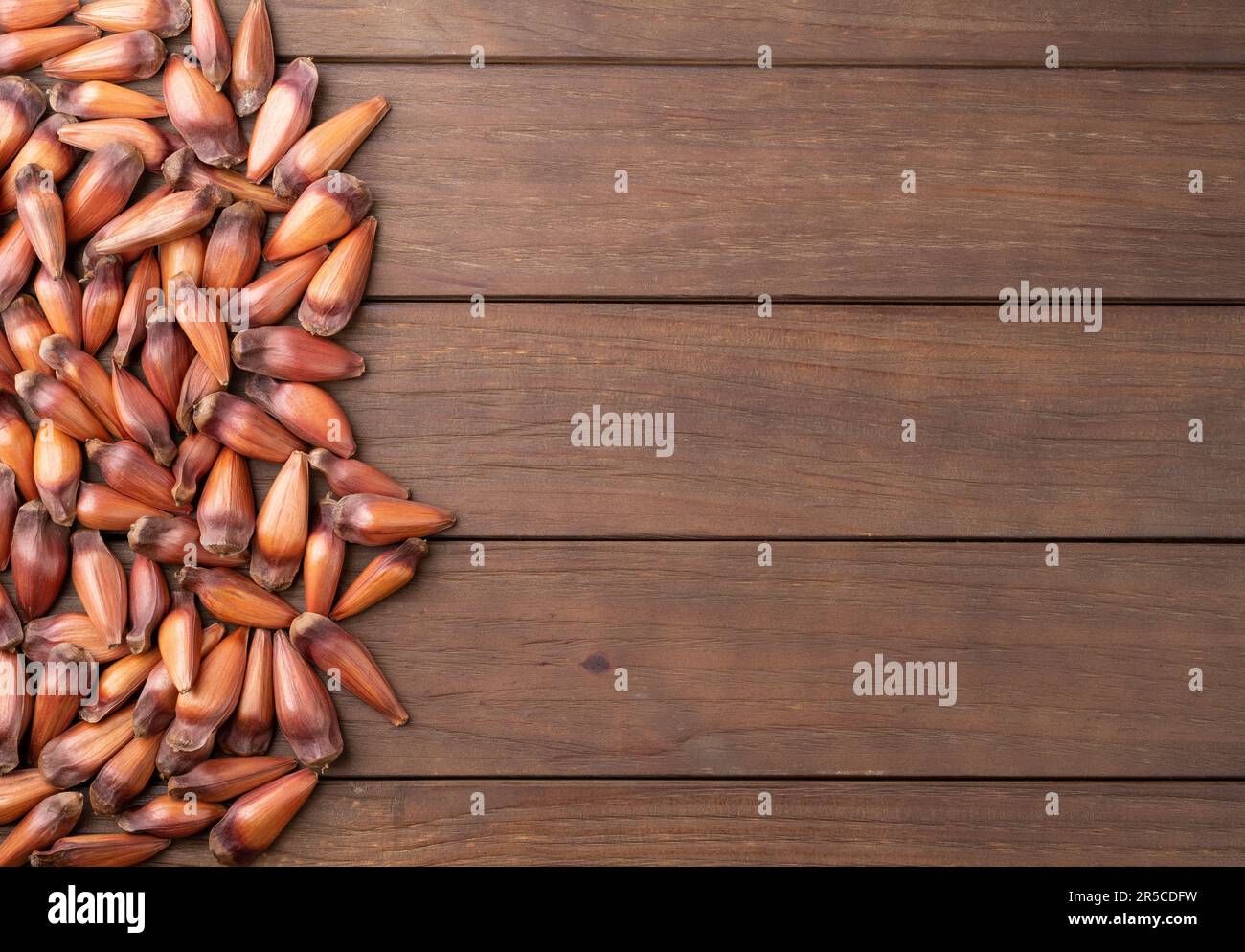 Pinions or pine tree seeds over wooden table with copy space Stock ...