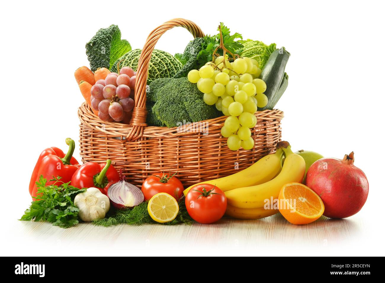 Composition with vegetables and fruits in wicker basket isolated on ...
