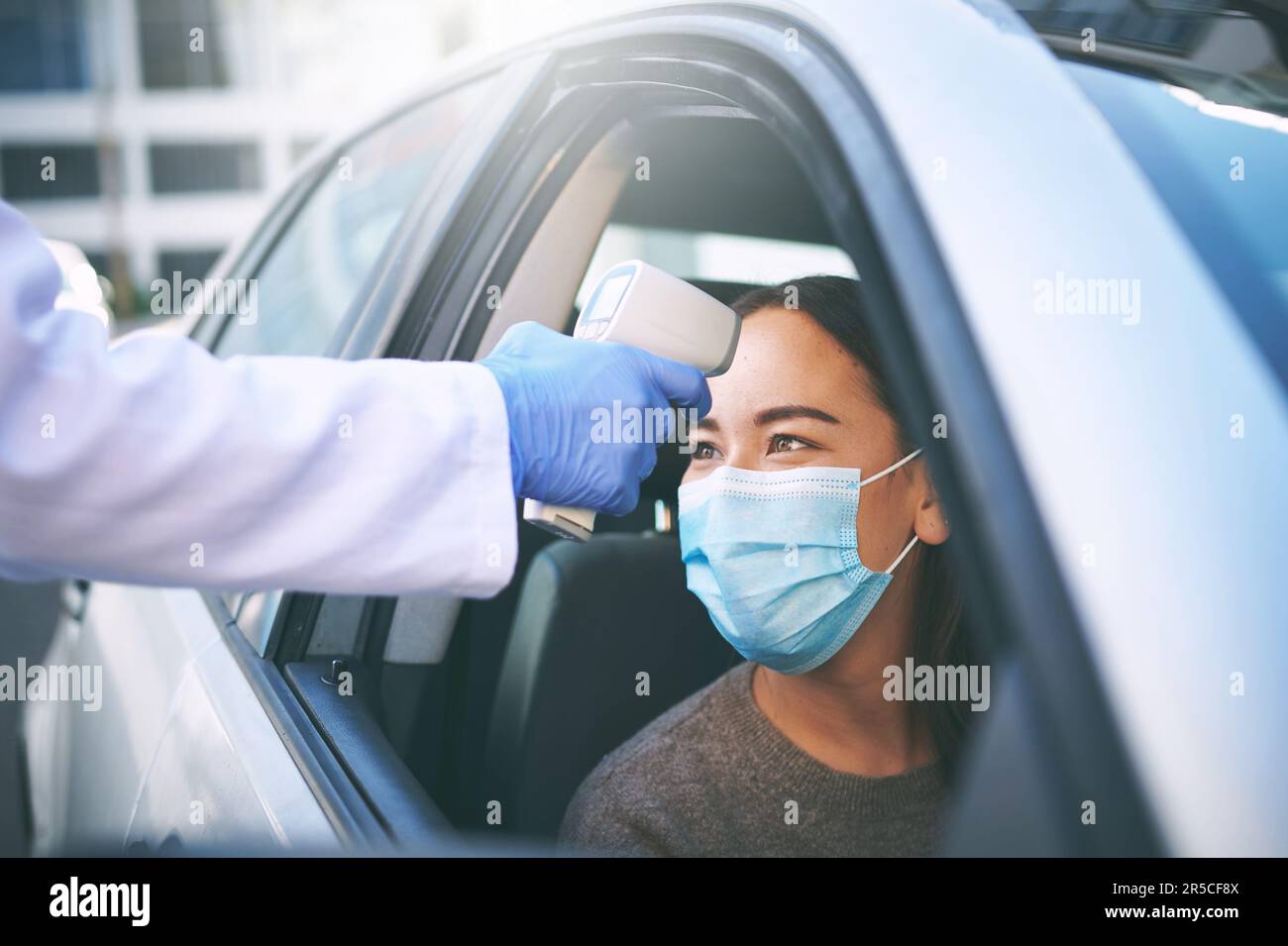 The digital way to detect a hidden virus. a masked young woman getting ...