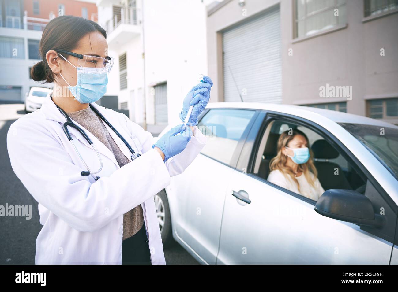 Keeping the community safe one shot at a time. a masked young doctor ...