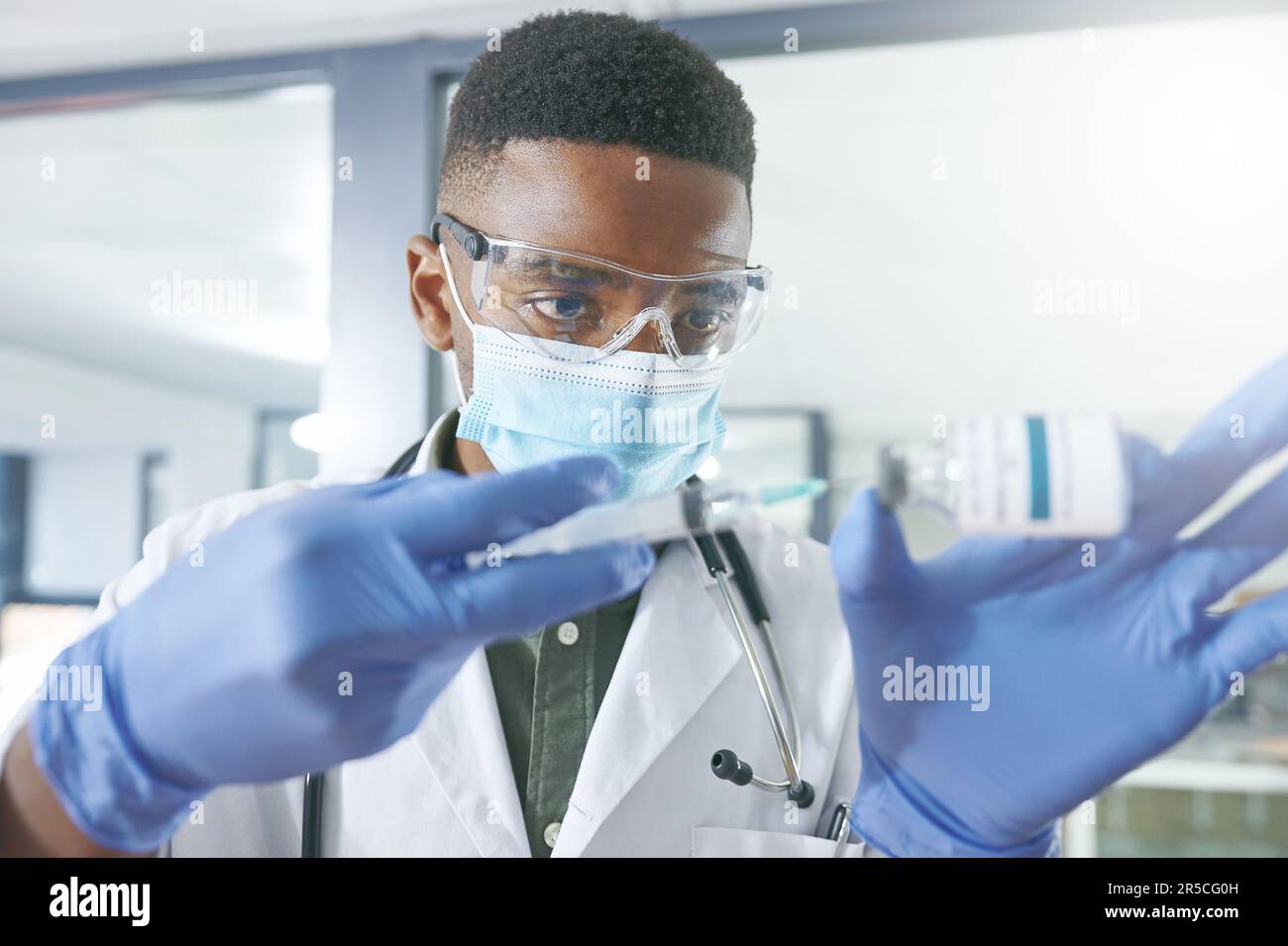 I have to be very careful with this. a young doctor extracting liquid ...