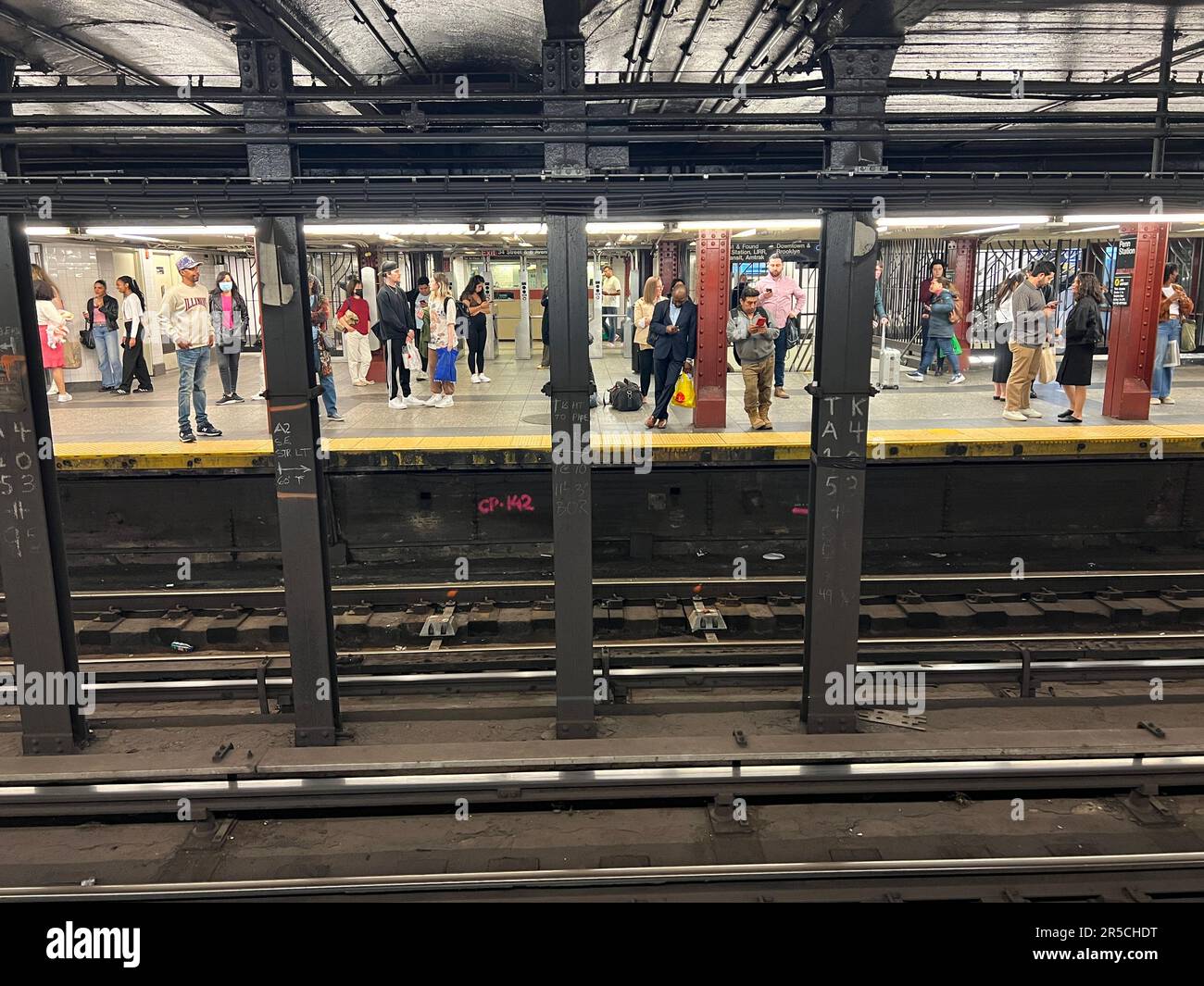 People wait for subway trains on the platform at 8th Avenue and 34th ...