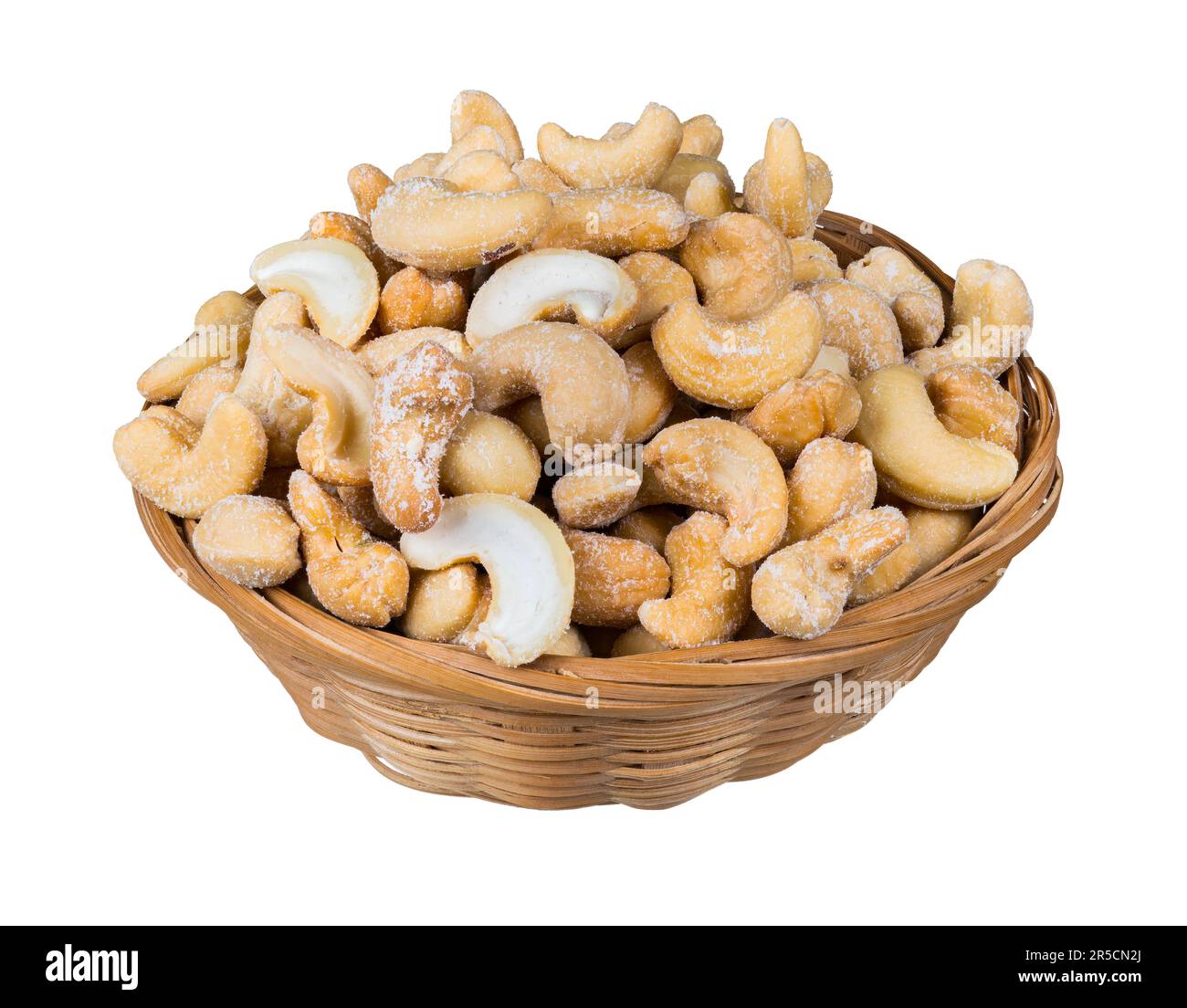 Salted roasted cashews in natural basket isolated on white background ...