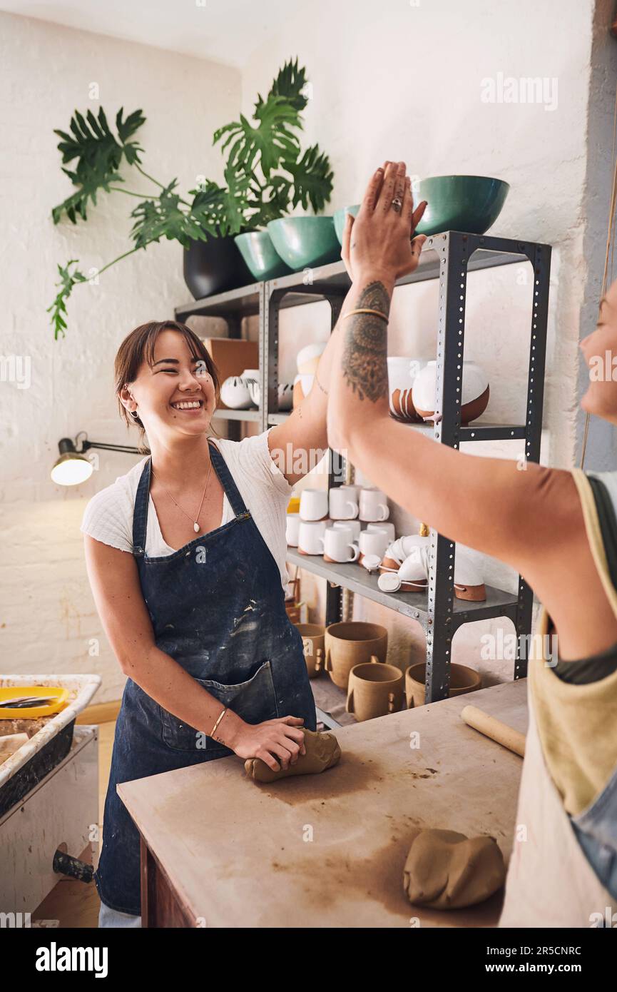High five for learning a new hobby. two young women giving each other a ...