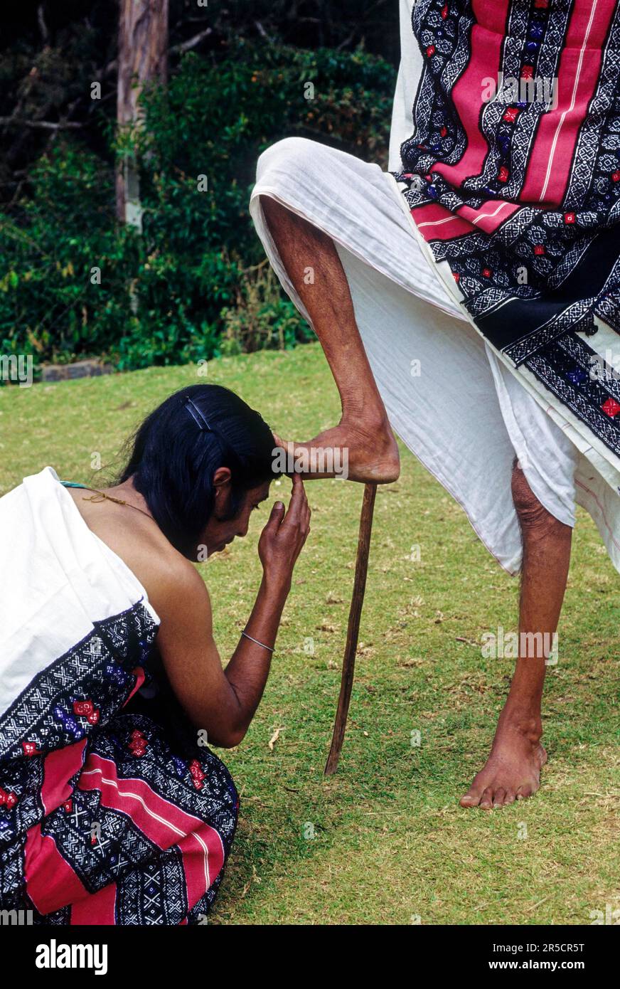 Toda, greeted by lifting their right foot and putting it in woman head ...