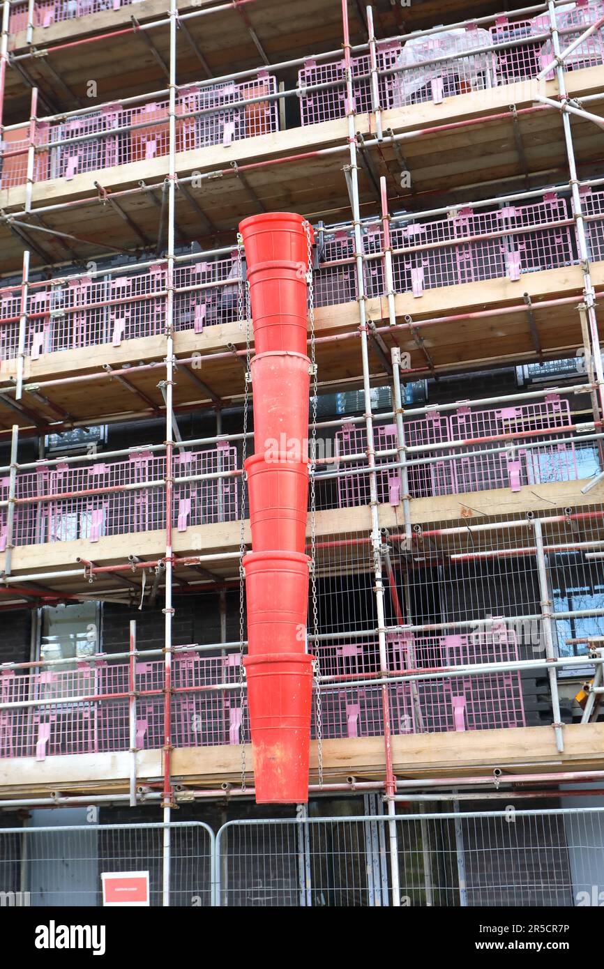scaffolding and a rubble shoot on building having work done Stock Photo ...
