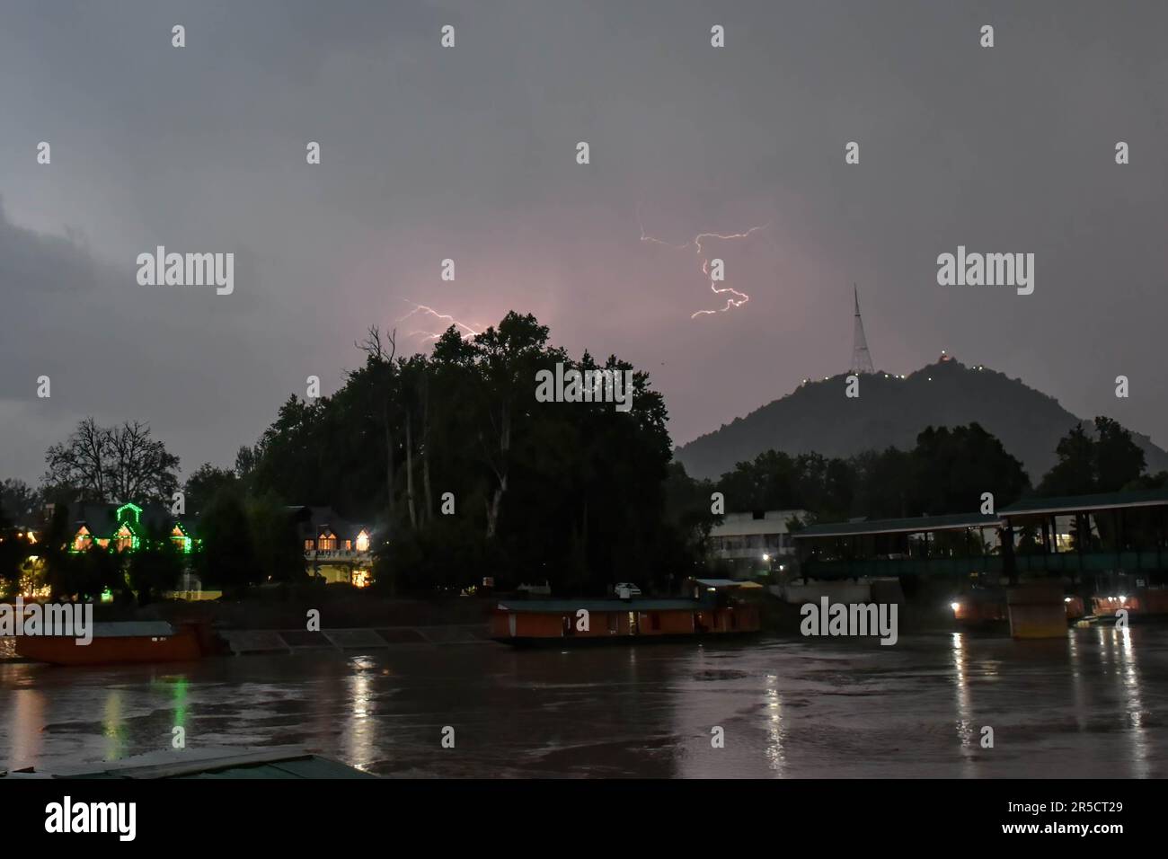 Lightning strikes over the river Jhelum during rainfall in Srinagar. As ...