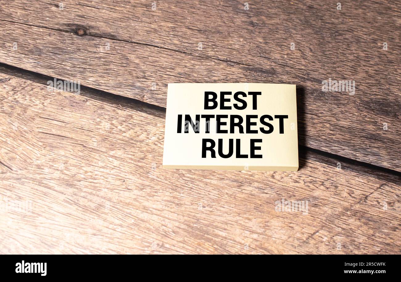 alarm clock with pink sticker with the text best interest rule Stock ...