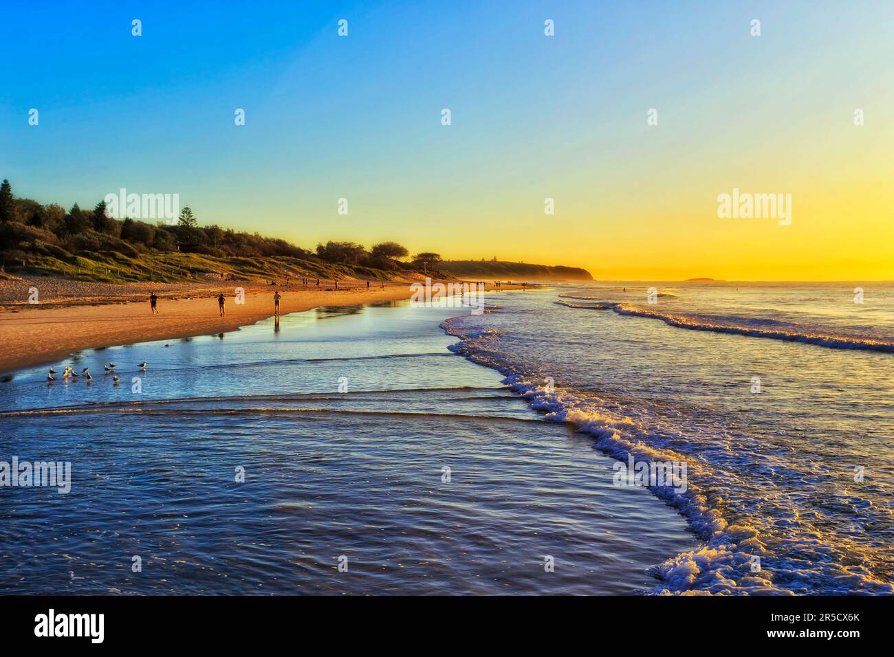 WIde sandy Caves beach at sunrise in soft light on pacific coast of ...