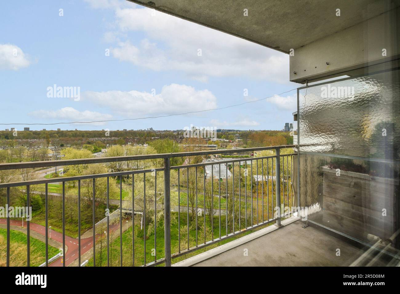 a balcony with a view of the city and hills in the distance, taken from ...