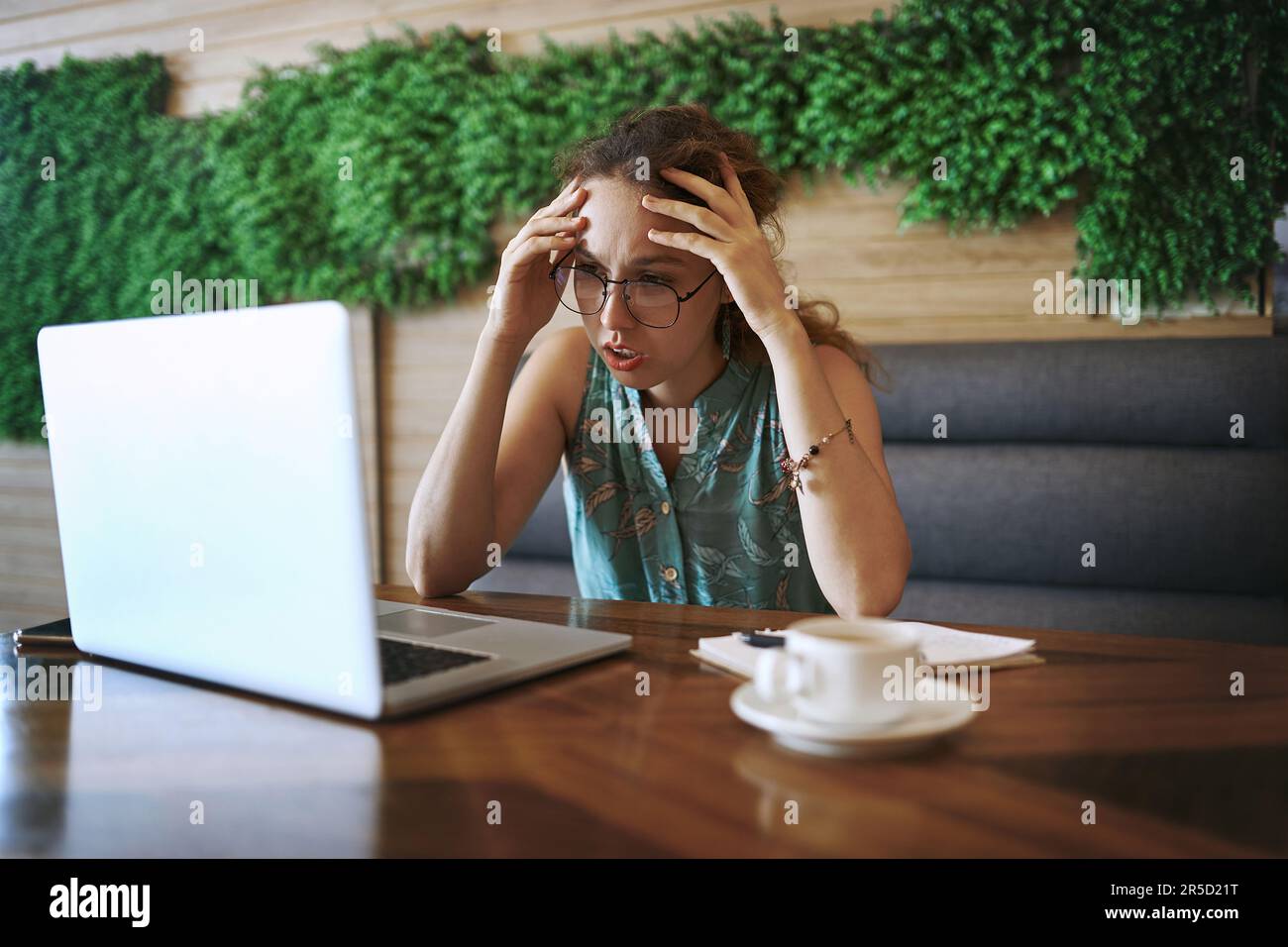 The stressful side of being self employed. a young woman using a laptop ...
