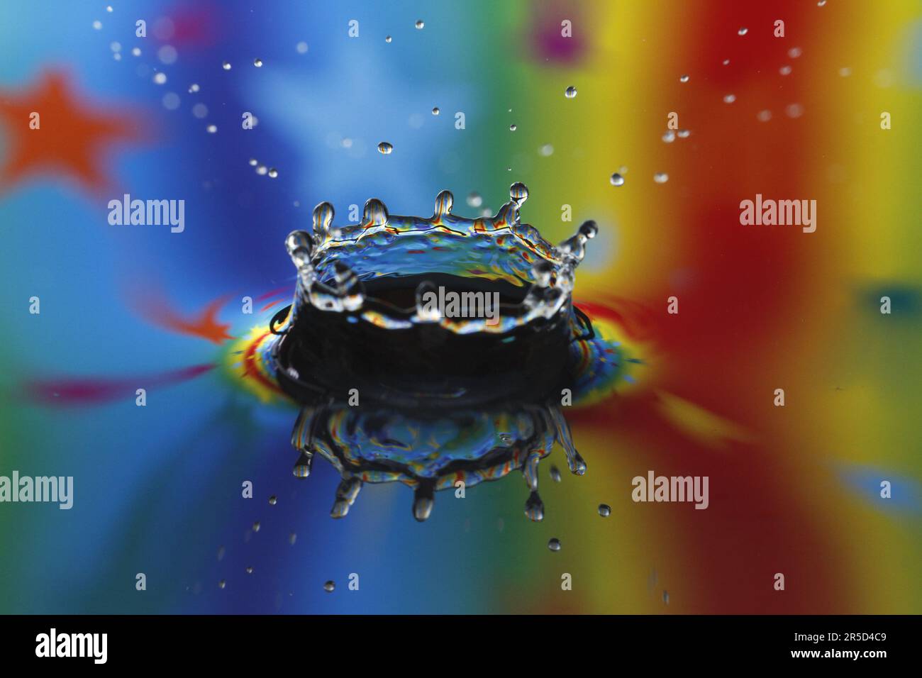 Beautiful water drops splashing on still water Stock Photo - Alamy