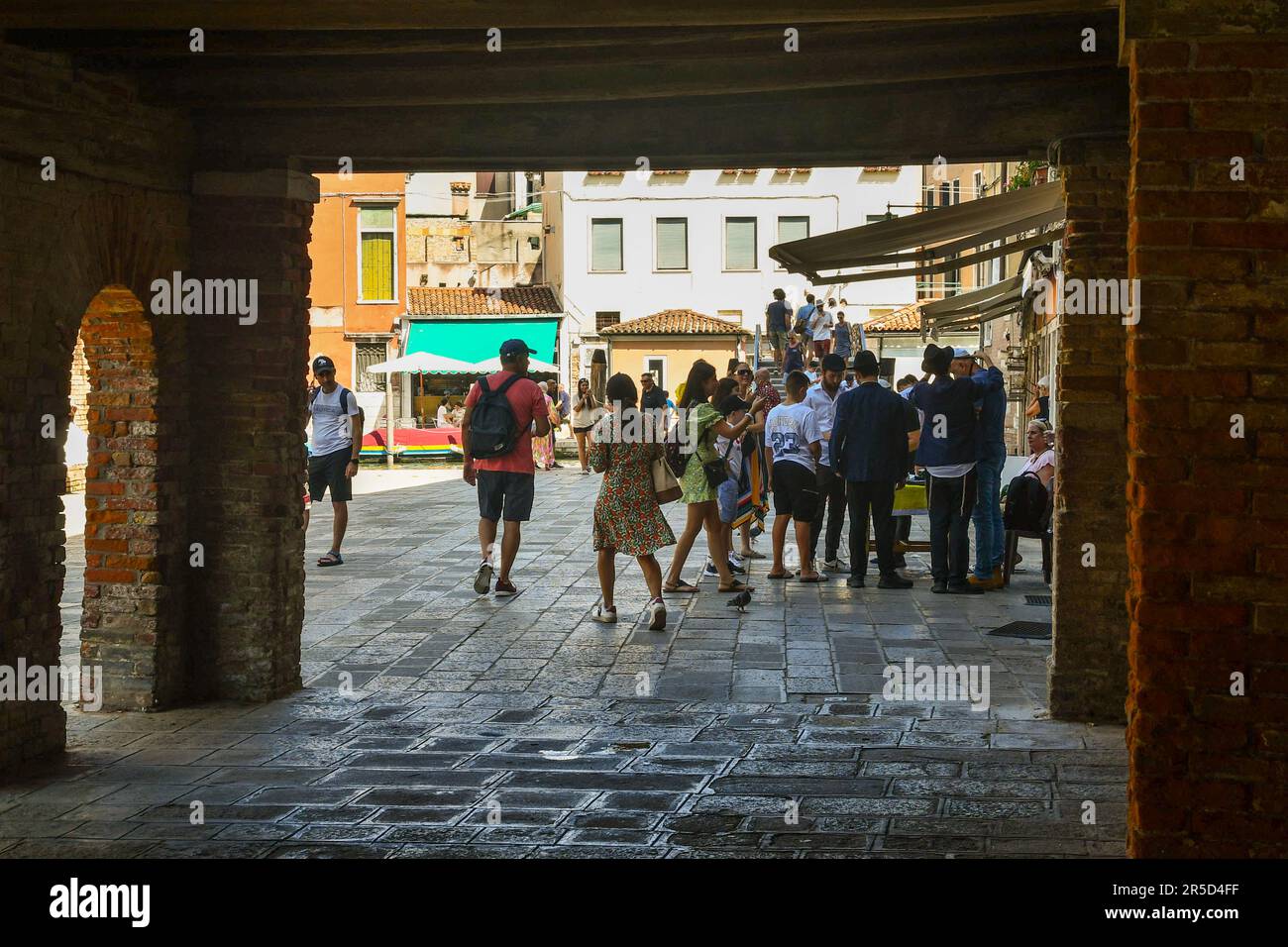 View from the Arcade of the New Ghetto with tourists and orthodox Jews ...