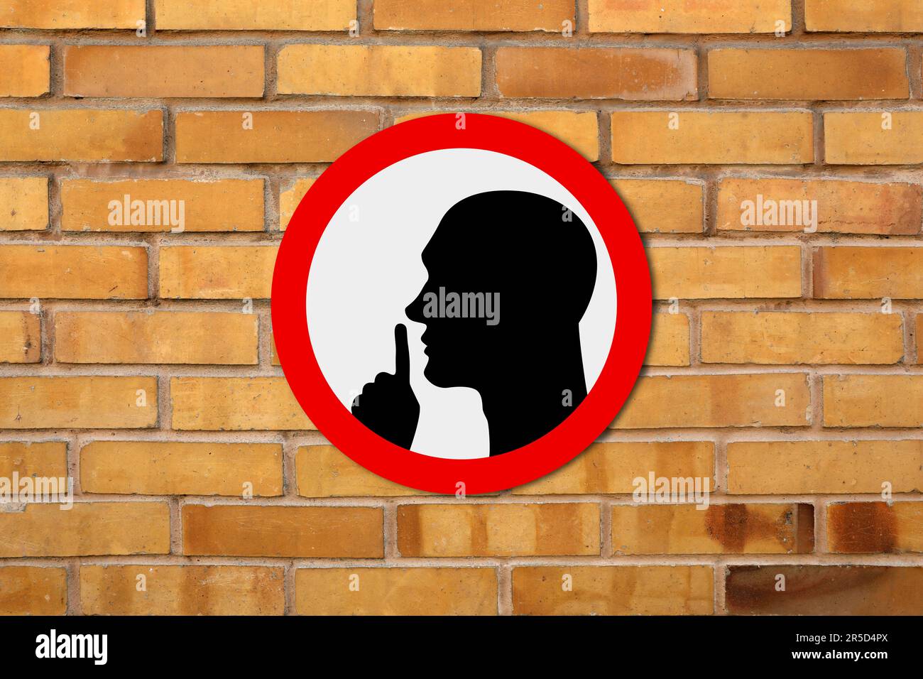Quiet Please sign with shush gesture image on orange brick wall Stock ...