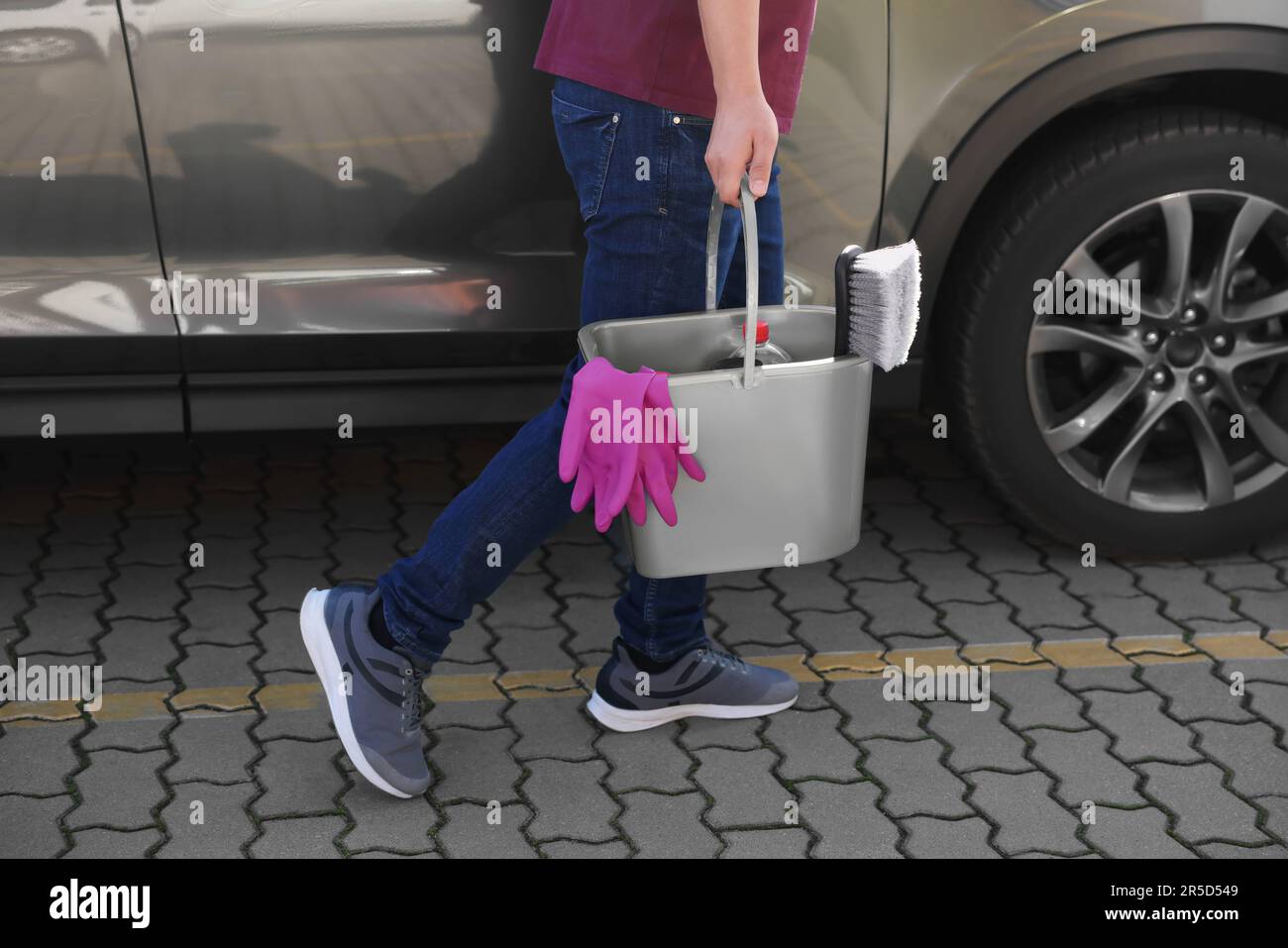 Man holding bucket with car cleaning products outdoors, closeup Stock ...