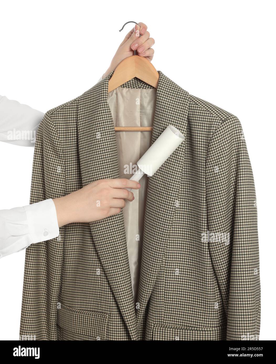 Woman cleaning suit with lint roller on white background, closeup Stock ...