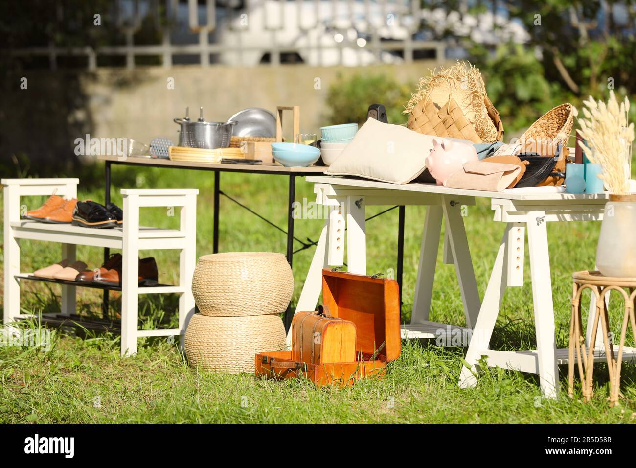 Small tables with many different items on garage sale in yard Stock ...