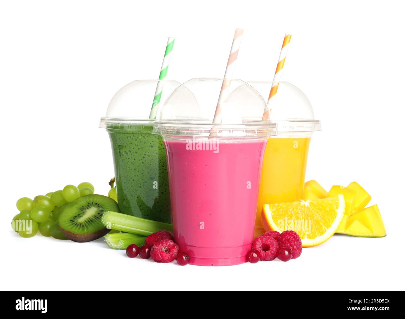 Plastic cups with delicious smoothies and ingredients on white ...