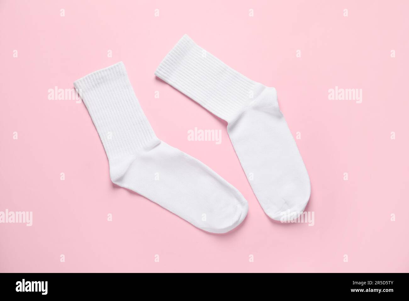 Pair of white socks on pink background, flat lay Stock Photo - Alamy