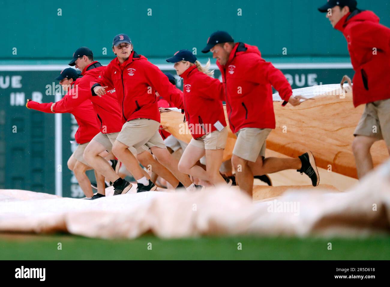The Fenway Park grounds crew brings out the tarp before a baseball game ...