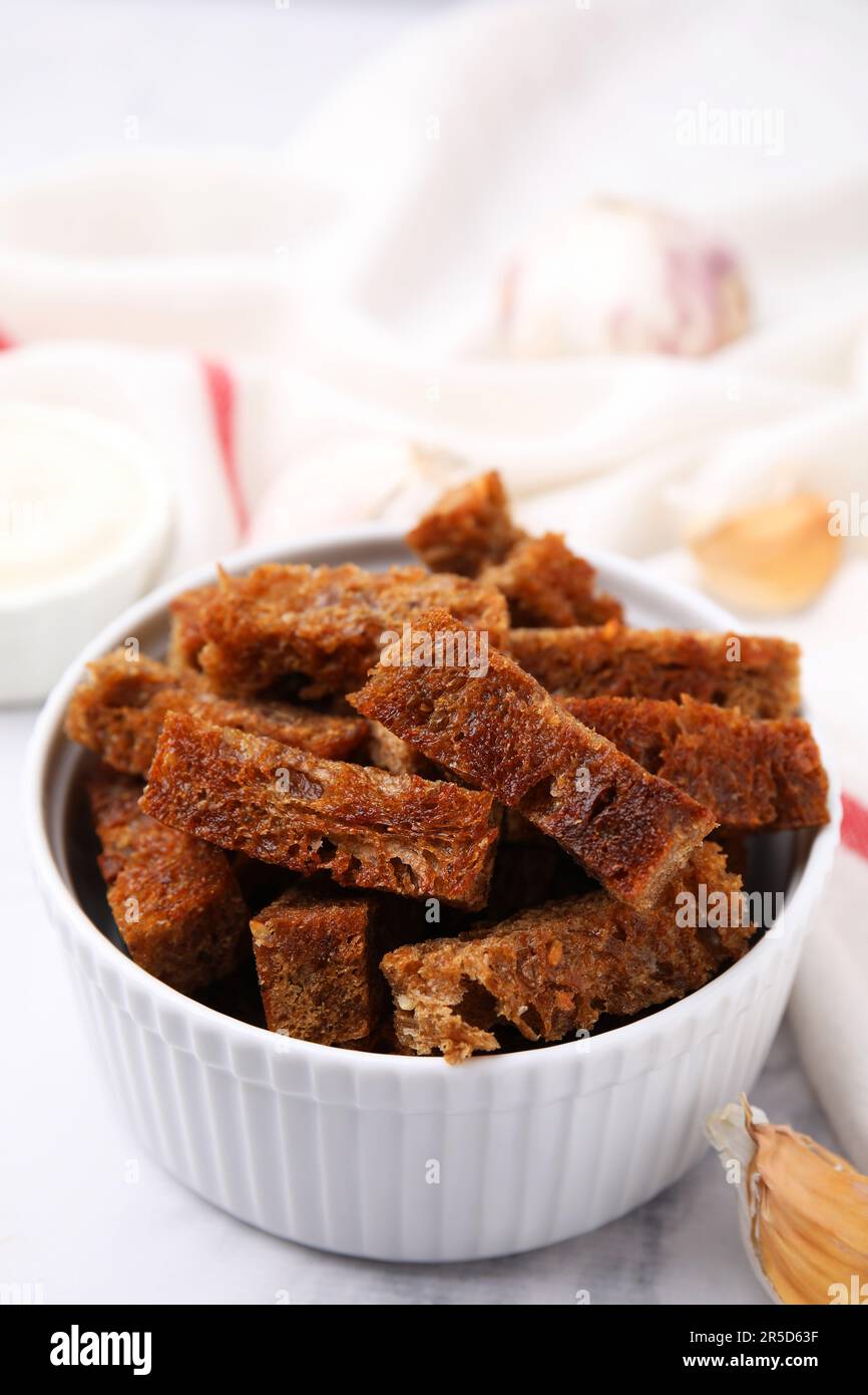 Crispy rusks and garlic on white marble table Stock Photo - Alamy