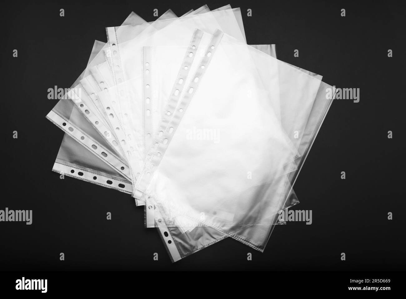 Punched pockets on black background, flat lay Stock Photo - Alamy