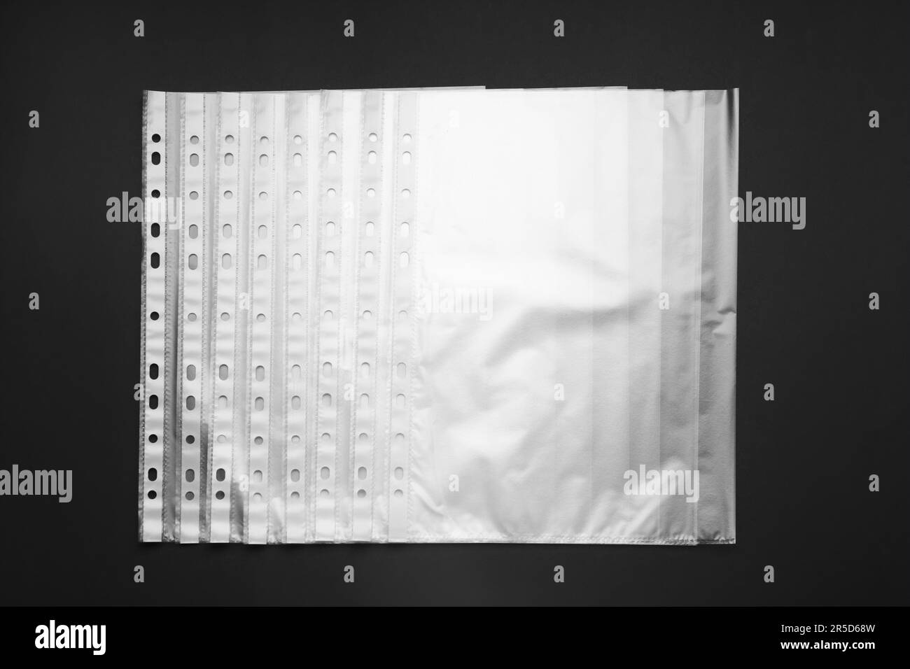 Punched pockets on black background, flat lay Stock Photo - Alamy