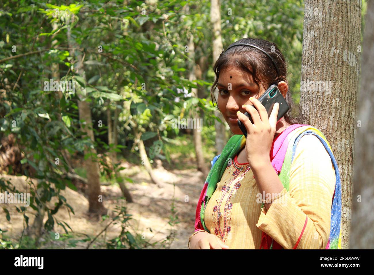 Young Indian Girl Chatting On Mobile Phone Outdoors Stock Photo - Alamy