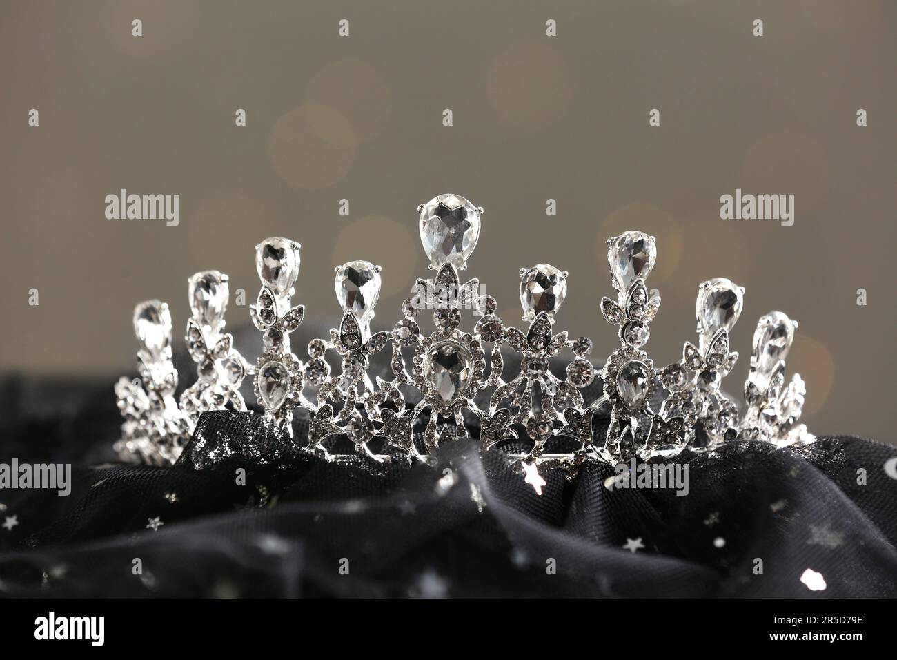 Beautiful silver tiara with diamonds on dark cloth Stock Photo - Alamy