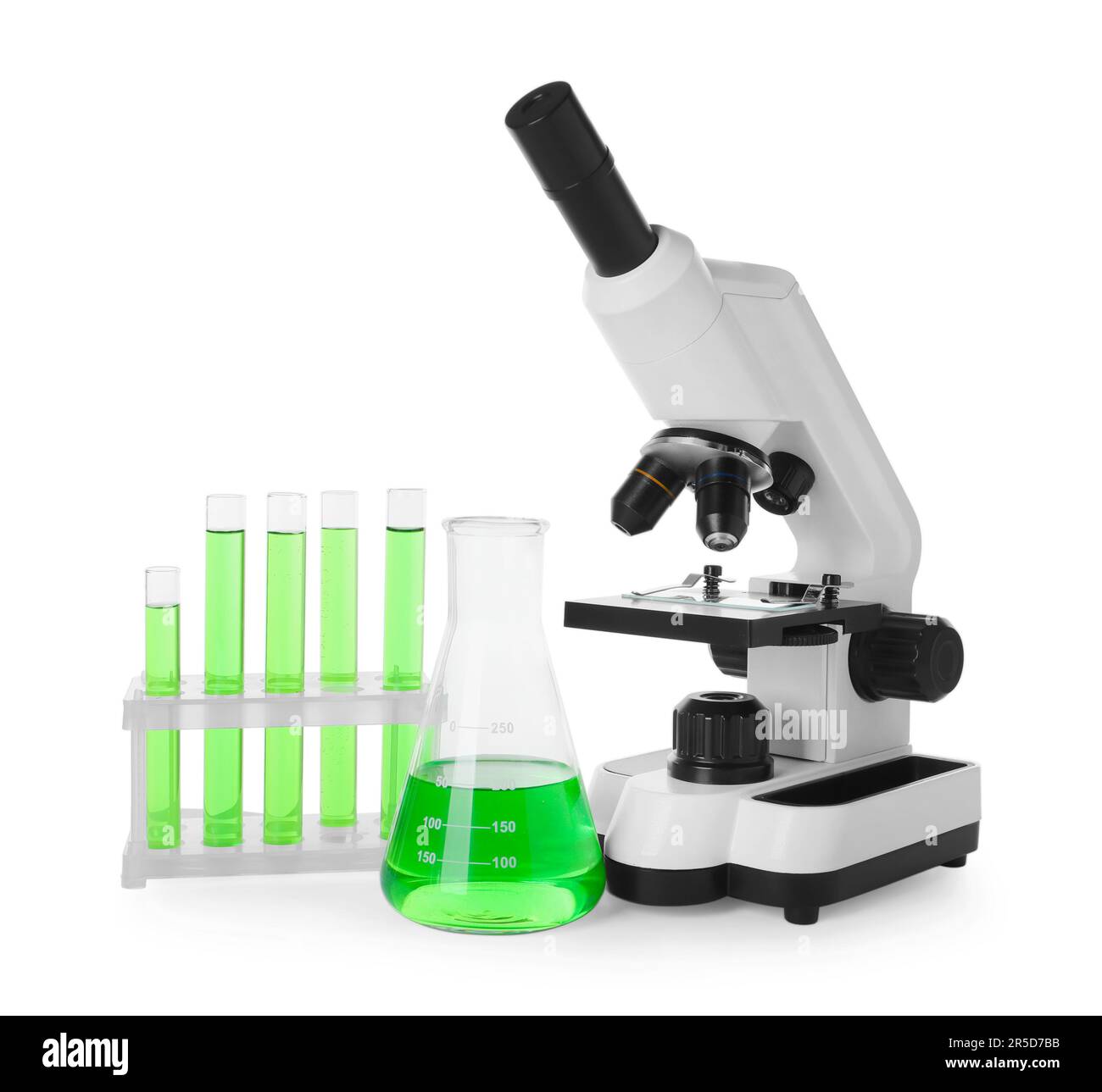 Laboratory glassware with green liquid and microscope isolated on white ...