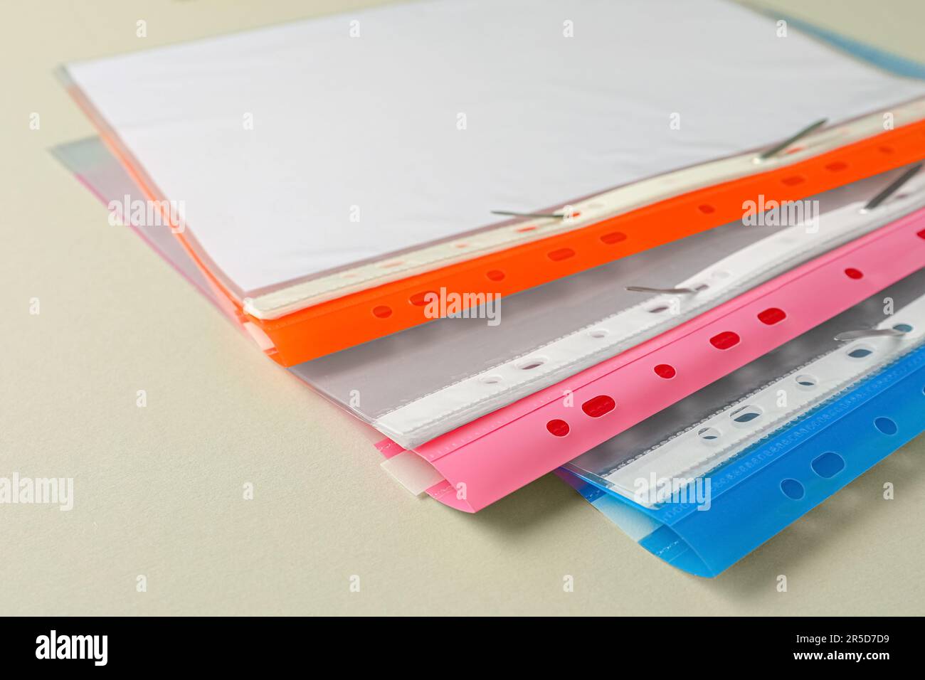 File folders with punched pockets on light grey background, closeup ...